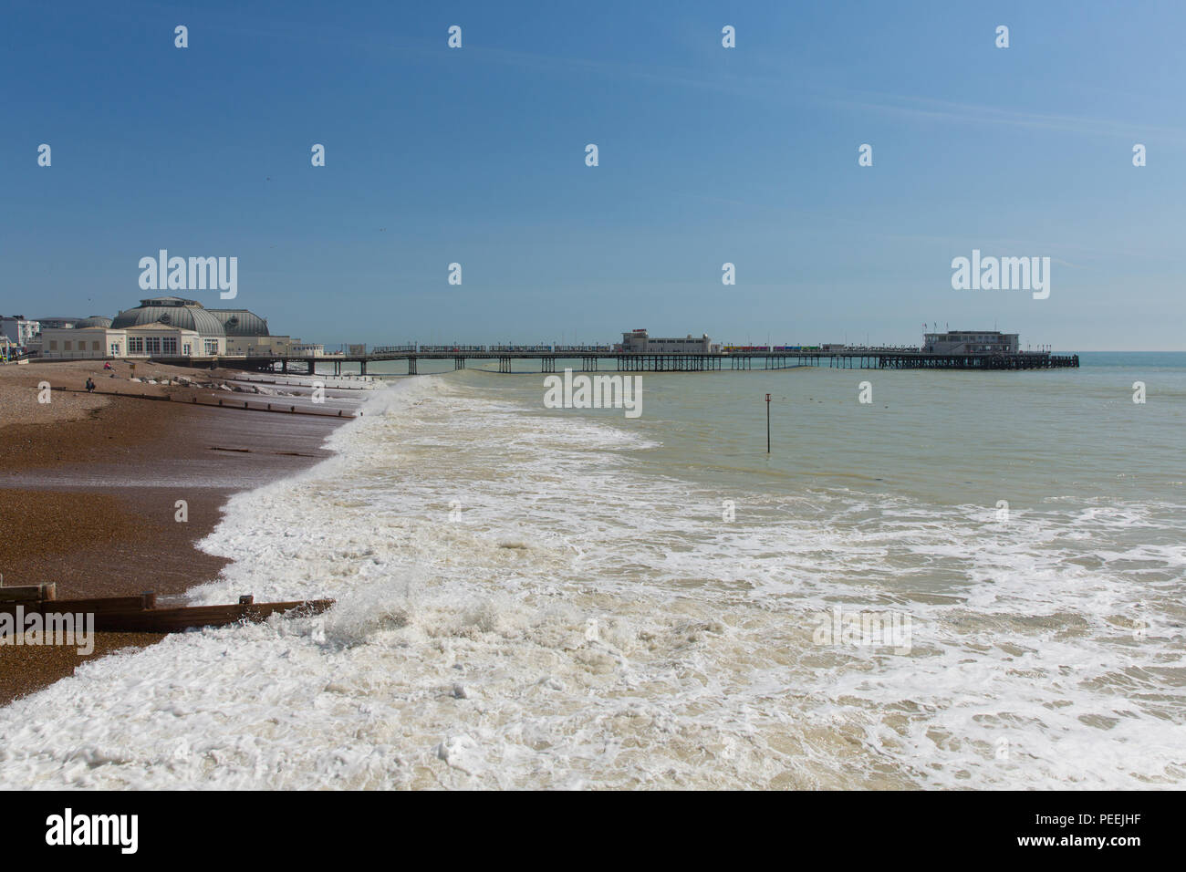 Worthing pier West Sussex England UK with waves and beach Stock Photo ...