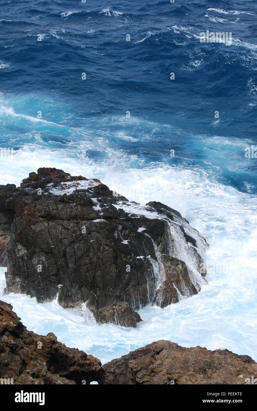 Lava rock with waves crashing on to the rocks in Aruba Stock Photo - Alamy