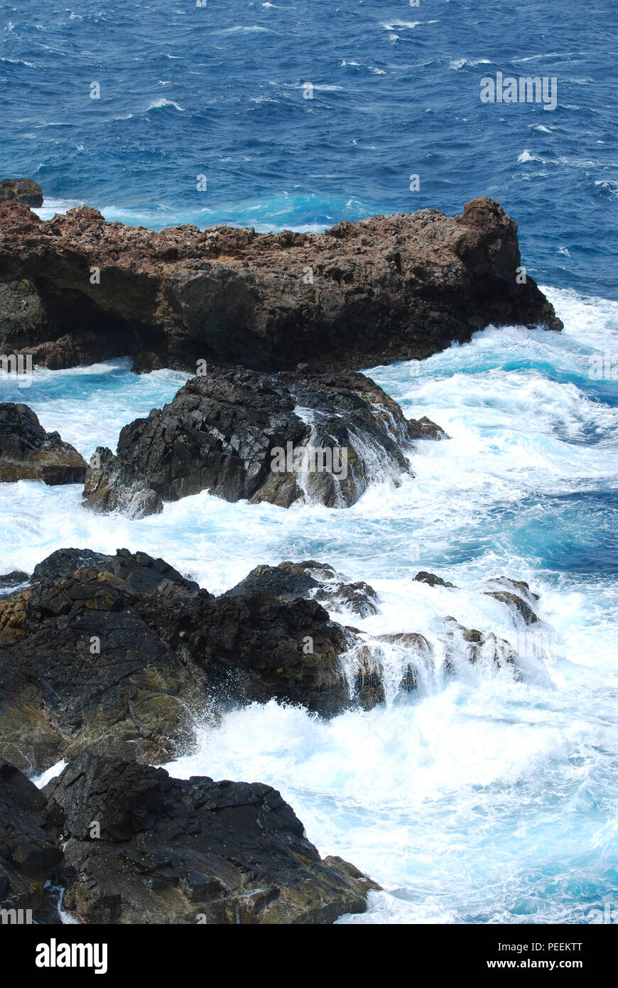 Lava rocks jutting into the ocean in Aruba Stock Photo - Alamy