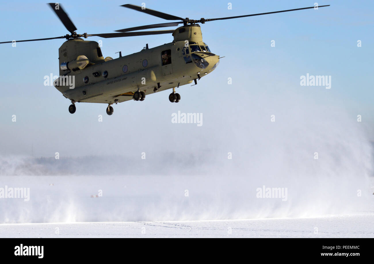 A U.S. Army CH-47 Chinook helicopter lands in the snow during an ...