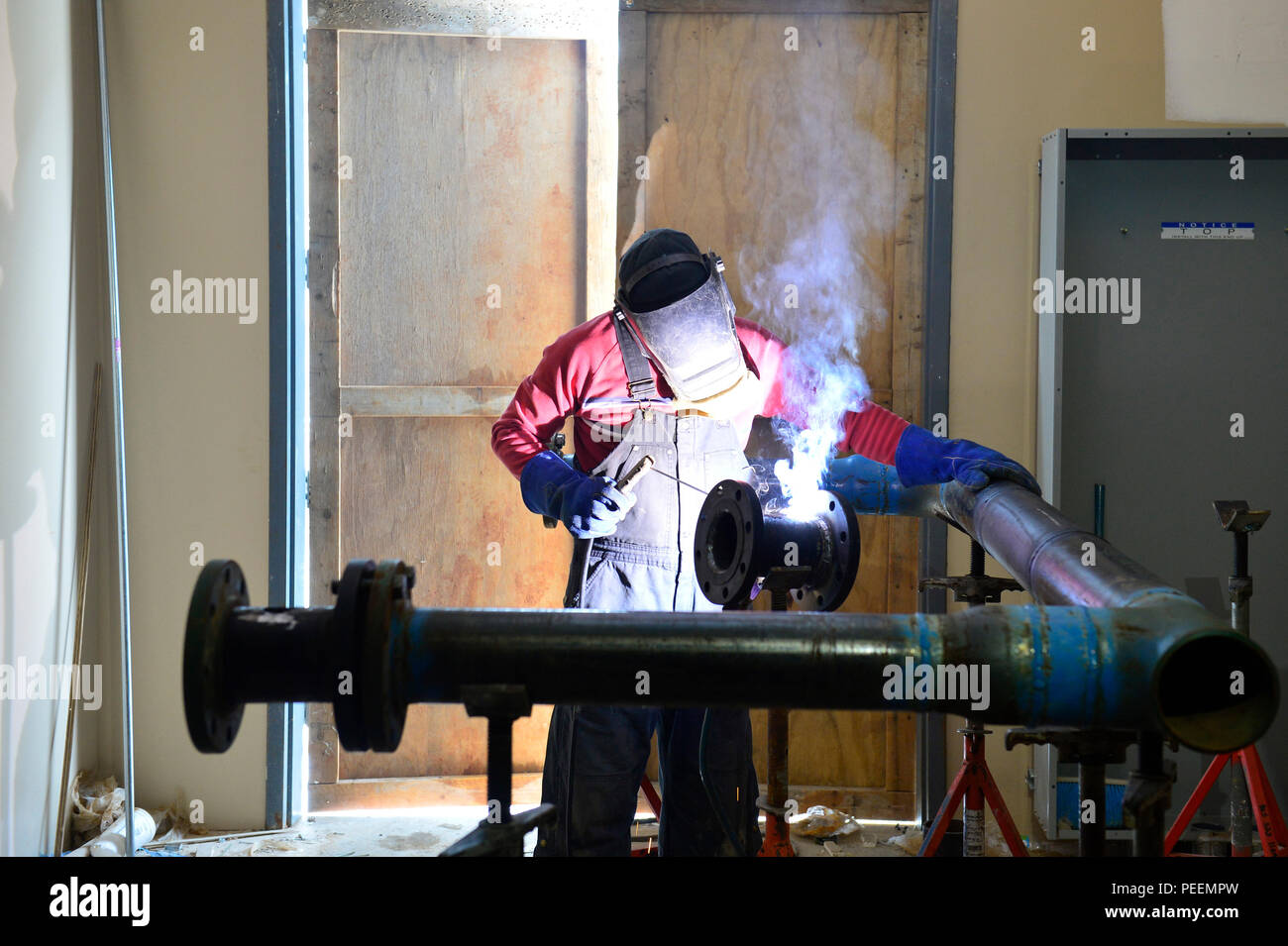 A welder constructs a 4-inch coupler for a chiller pipe here, Jan. 21 ...