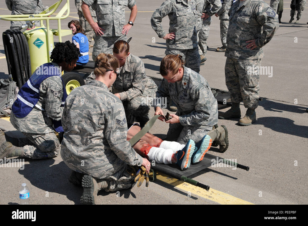 Airmen secure a simulated casualty victim on a litter during a mass ...