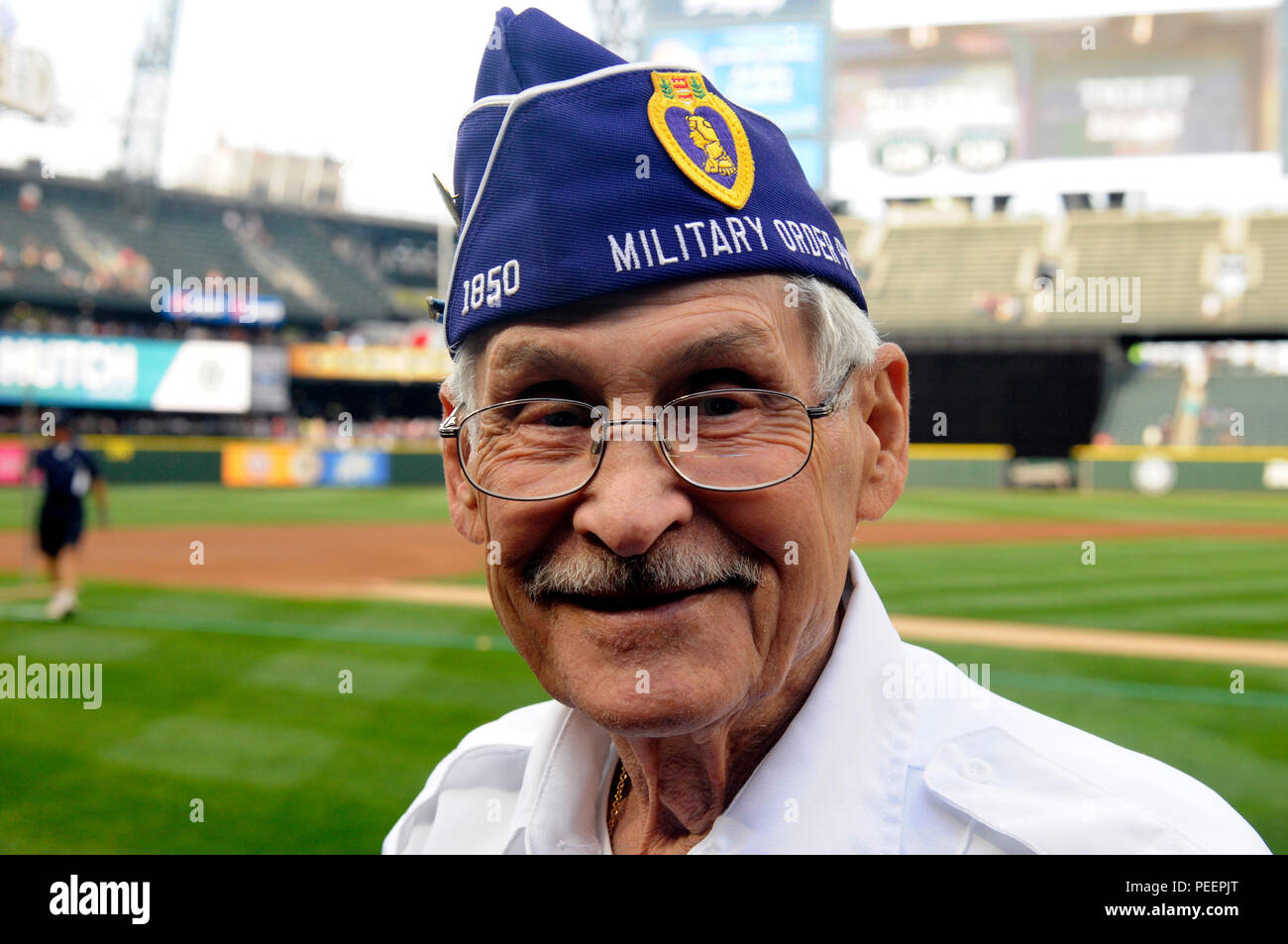 Phil Sacks, a purple heart recipient, prepares to throw out the ...