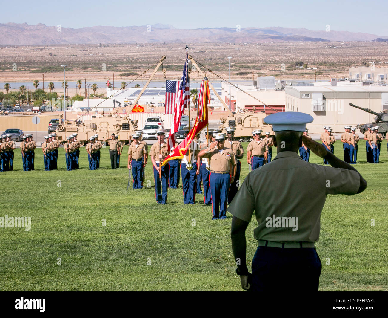Marines salute during the playing of the National Anthem at a ...