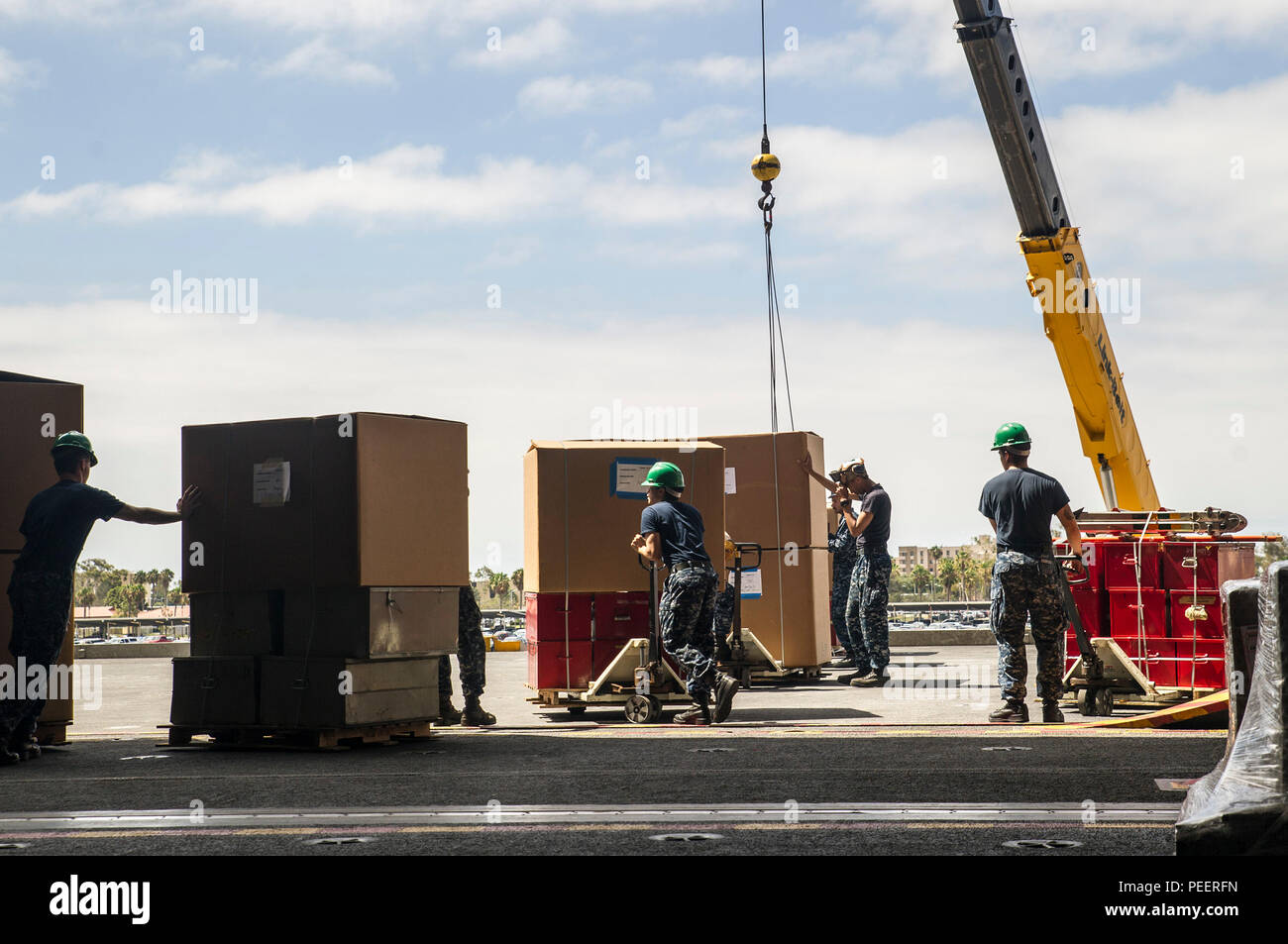 150811-N-EH855-079 SAN DIEGO (Aug. 11, 2015) Sailors transport cargo on ...