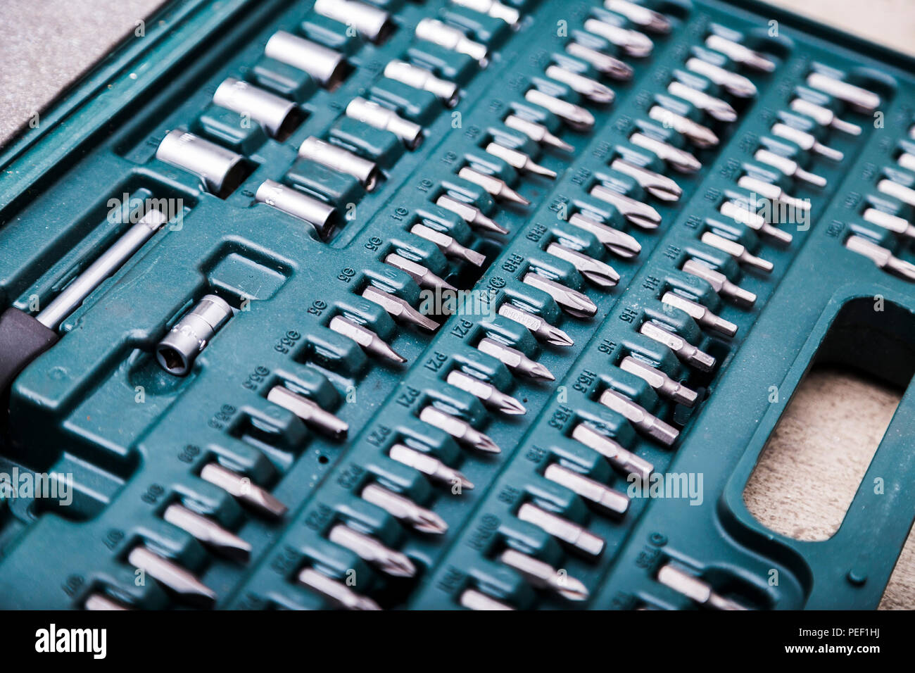Set of metal heads for screwdriver in green box Stock Photo - Alamy