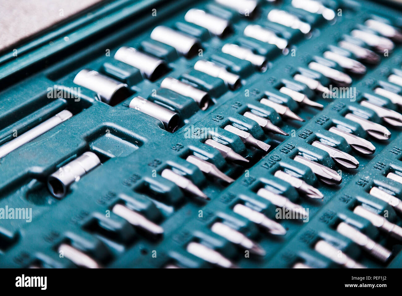 Set of metal heads for screwdriver in green box Stock Photo - Alamy