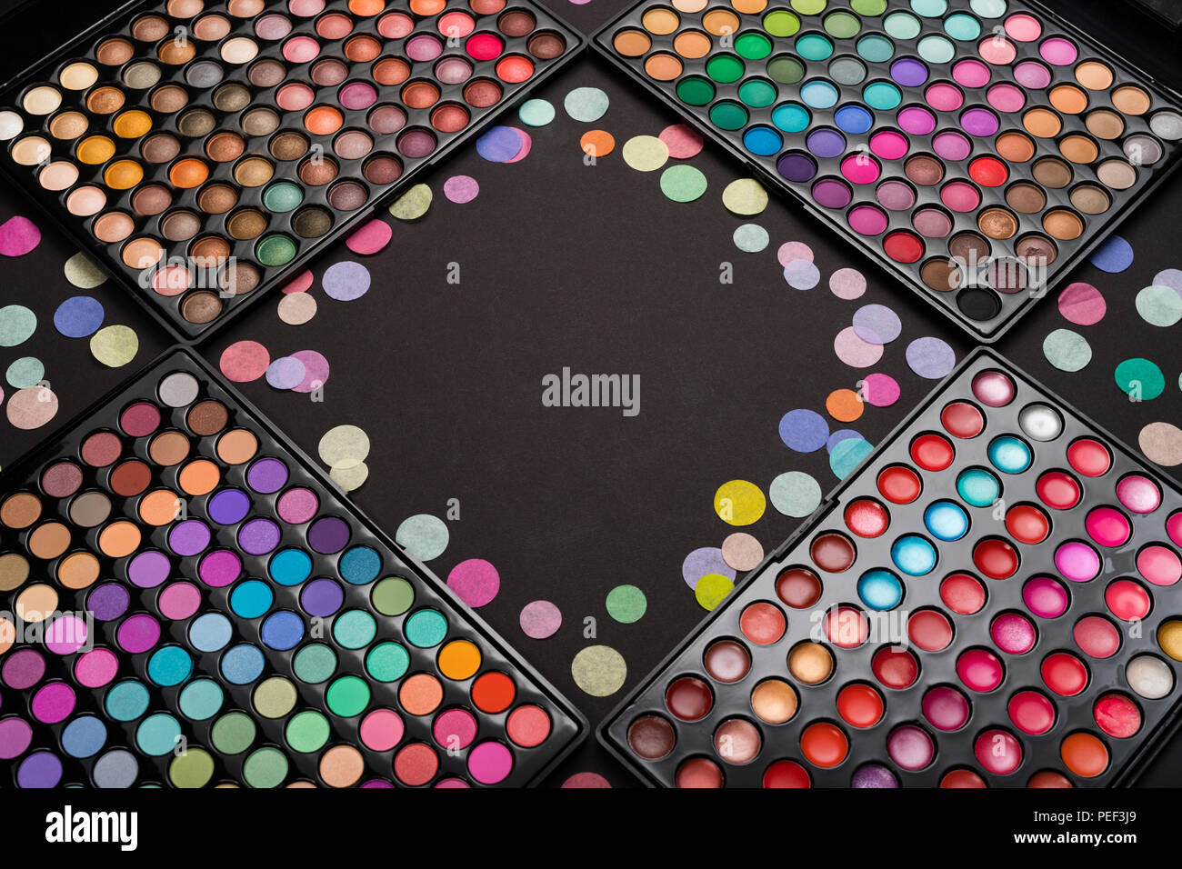 Make-up eyeshadow palettes with confetti scattered on black Stock Photo ...