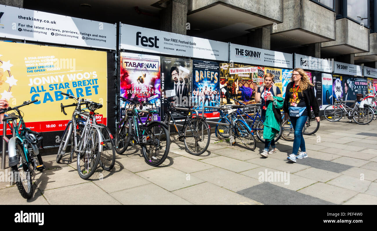 Two workers for the Assembly venue organisers walking past a bike rack ...