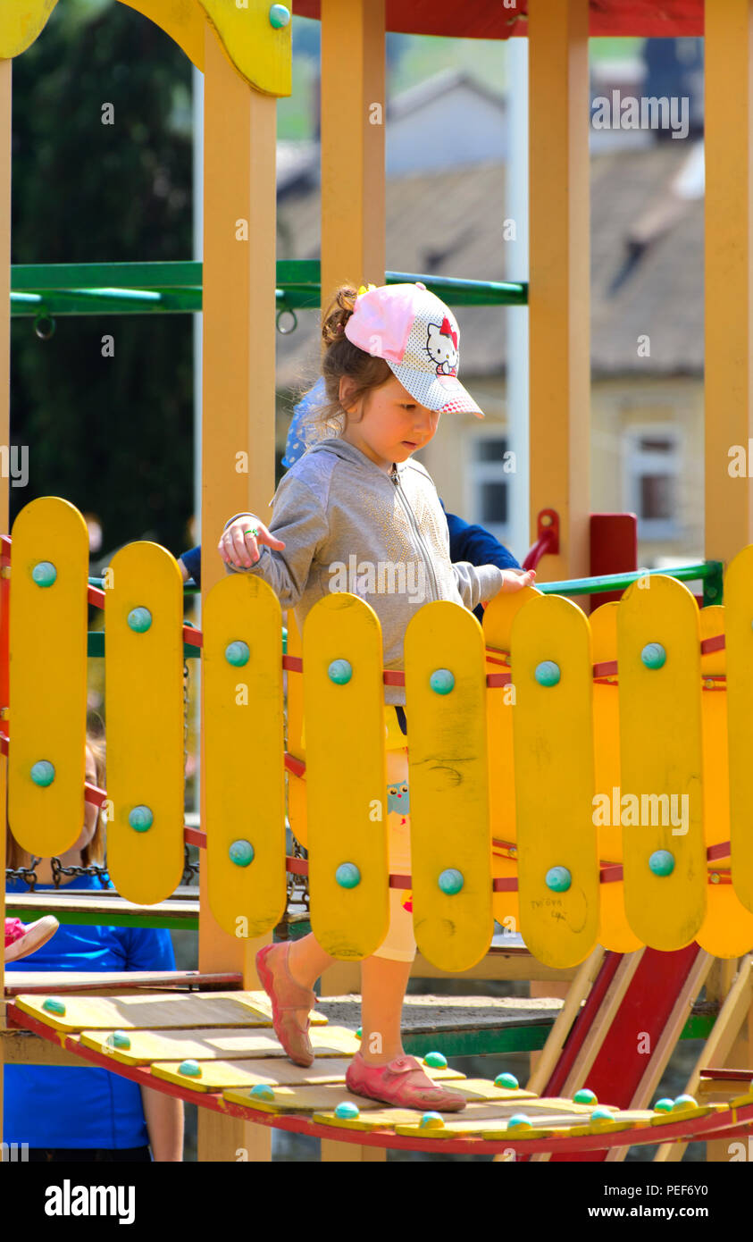 Little children run around and play in the playground. Game center for ...
