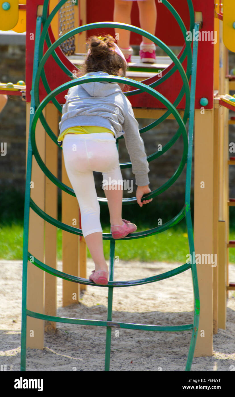 Little children run around and play in the playground. Game center for ...