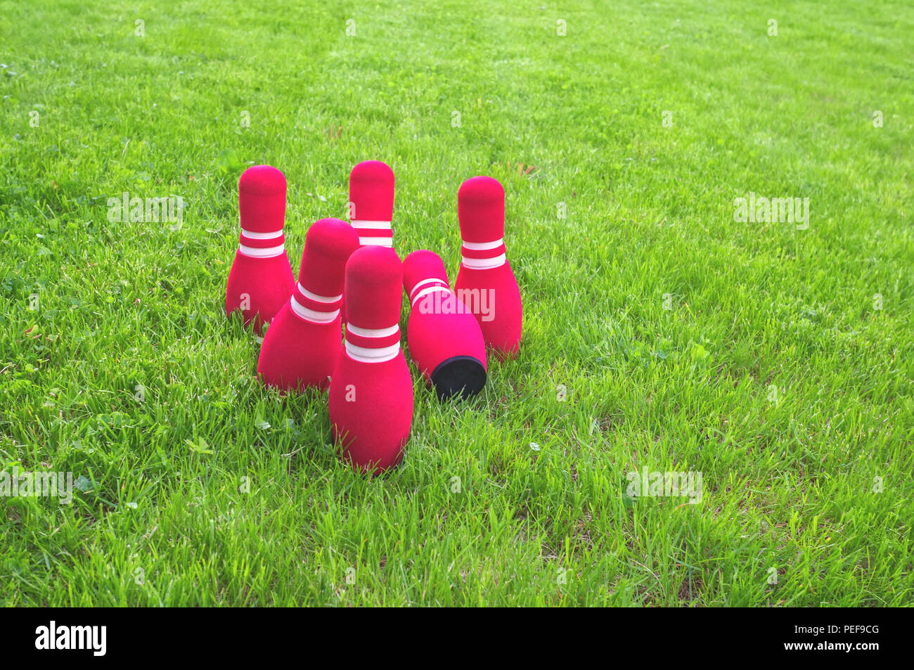 Red skittles. Summer. Children playground. On the green grass in the ...
