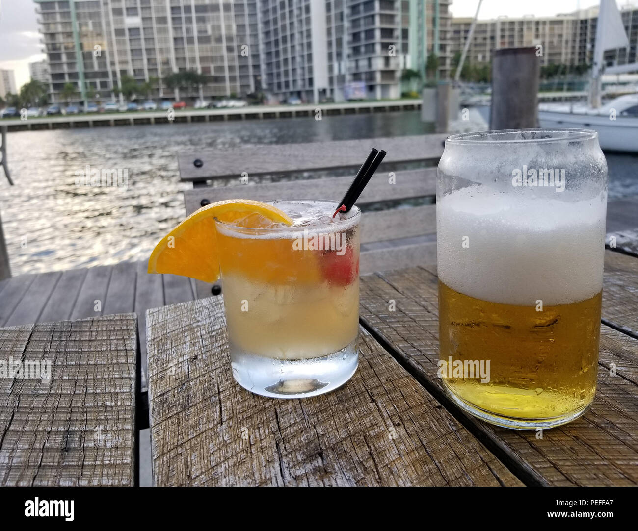 drinks alongside a waterfront view of a boat canal. summer time Stock ...