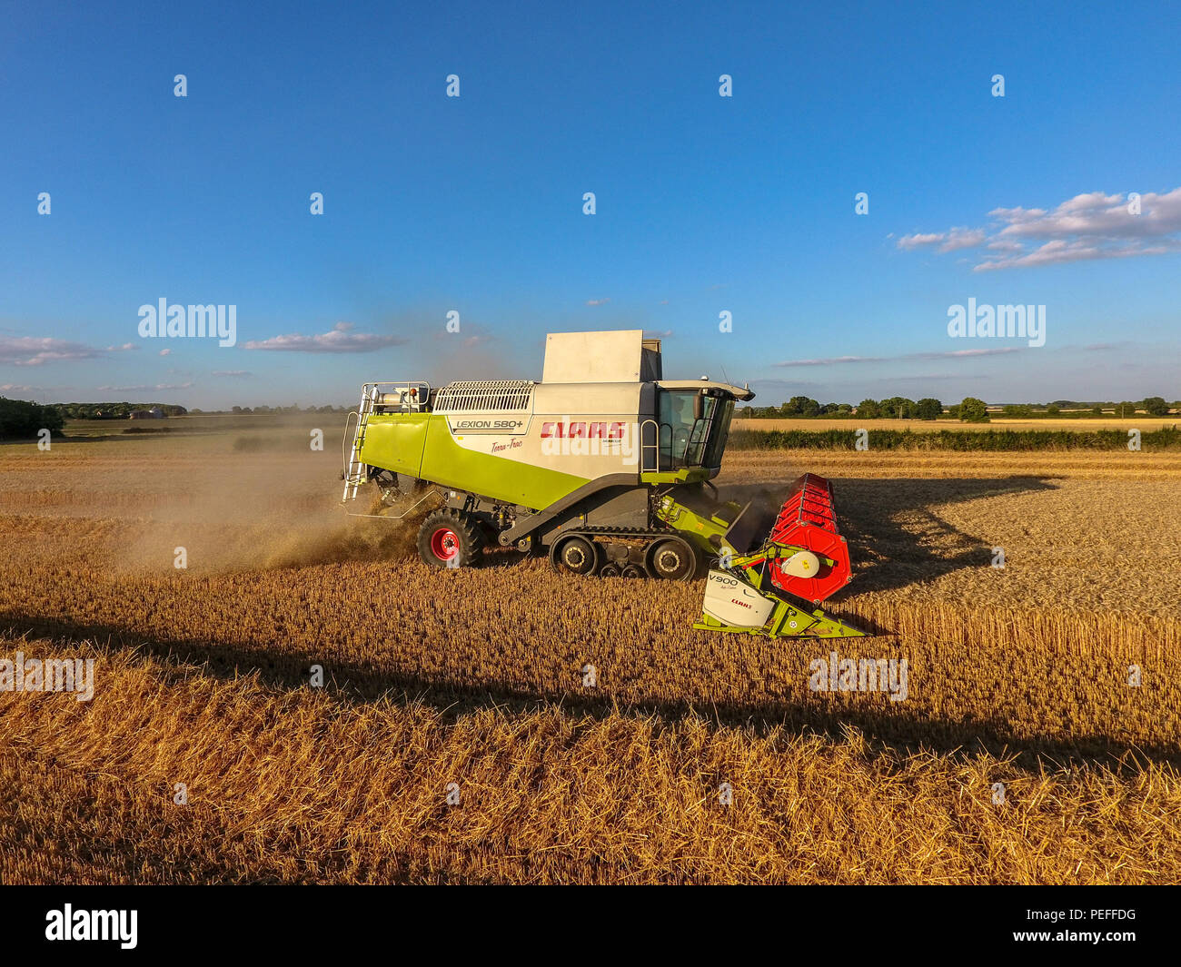 Combines cutting wheat field hi-res stock photography and images - Alamy