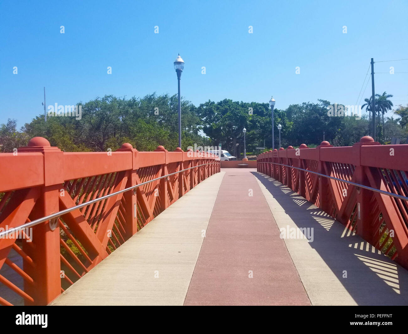 A colorful red pedestrian bridge over a canal. in Coral Gables, Florida ...