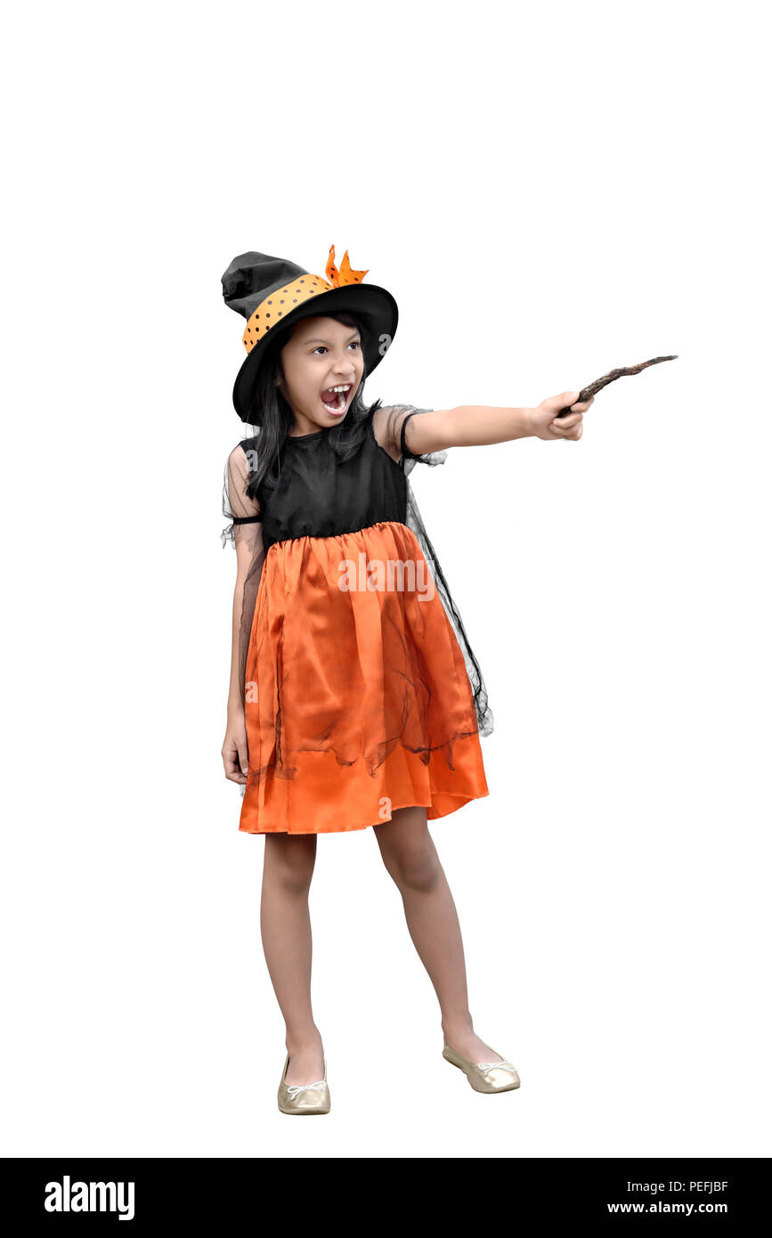 Portrait of asian little witch girl with a magic wand posing isolated ...