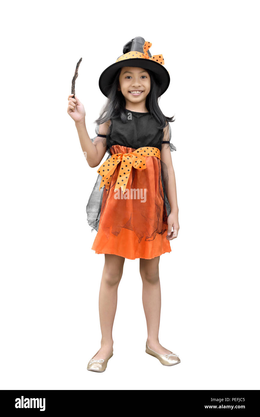 Portrait of asian little girl with witch costume and magic wand ...