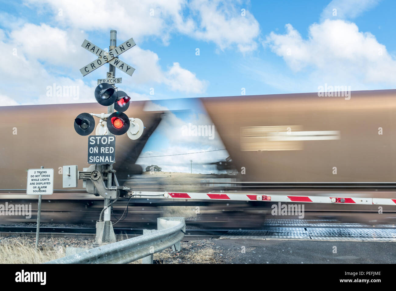 Train driving across road hi-res stock photography and images - Alamy