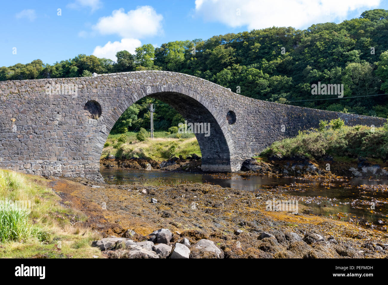 Historic stone Clachan Bridge (Atlantic Bridge) connecting the Isle of ...