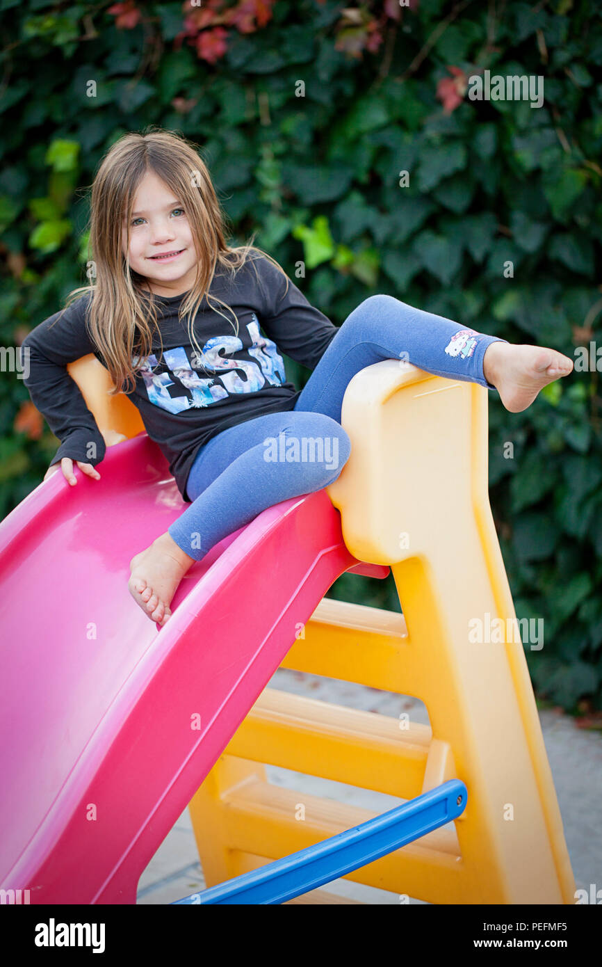 Portrait of a pretty young girl on slide Stock Photo - Alamy