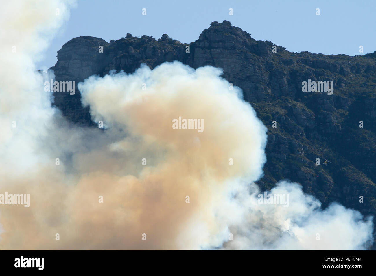 Firefighters tackle a forest fire on table mountain using helicopters ...