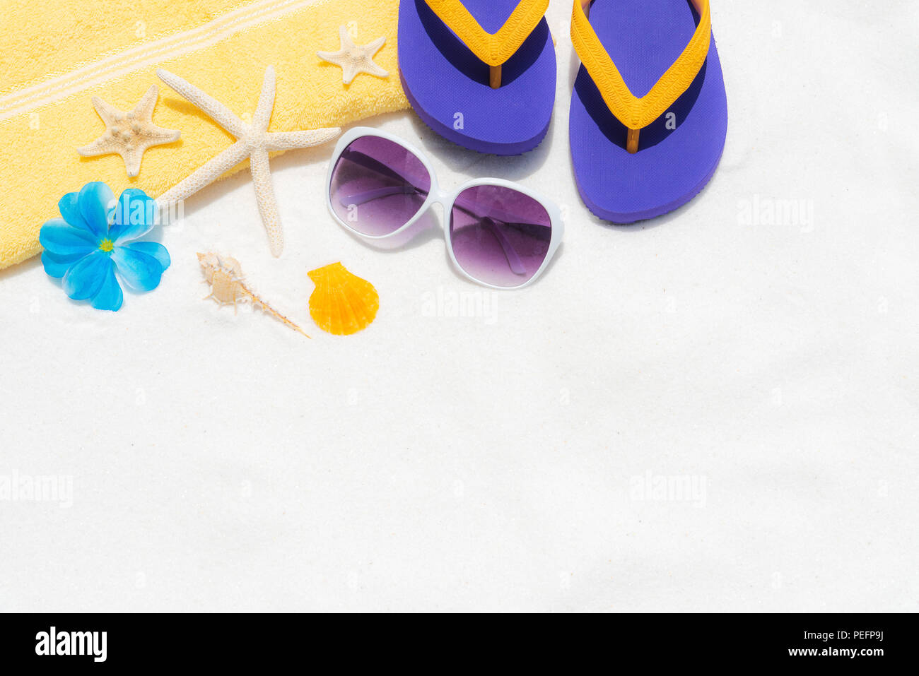 Beach accessories including sunglasses, starfish, colorful flip flop ...