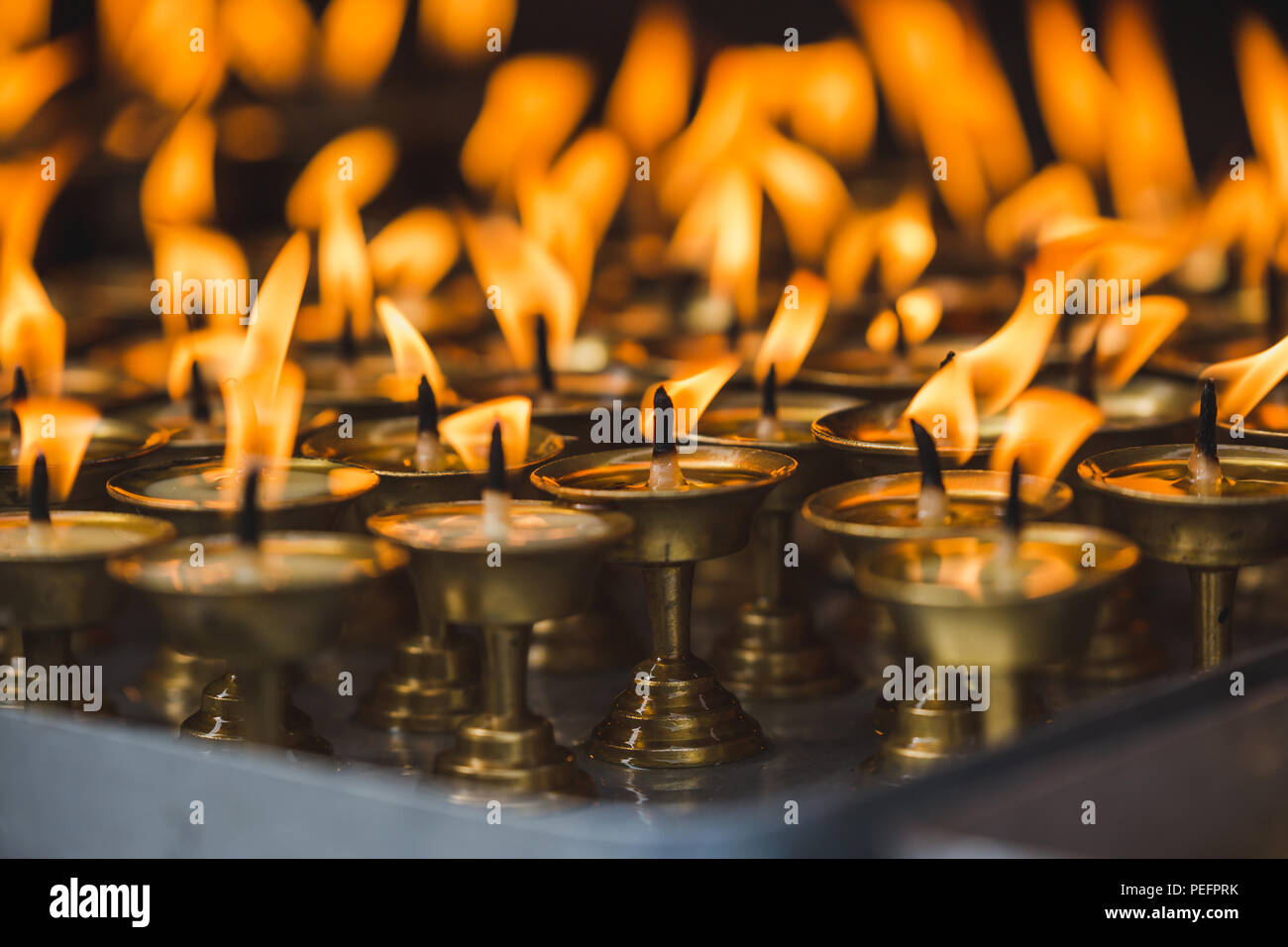 Oil butter lamps burning in hindu temple hi-res stock photography and ...