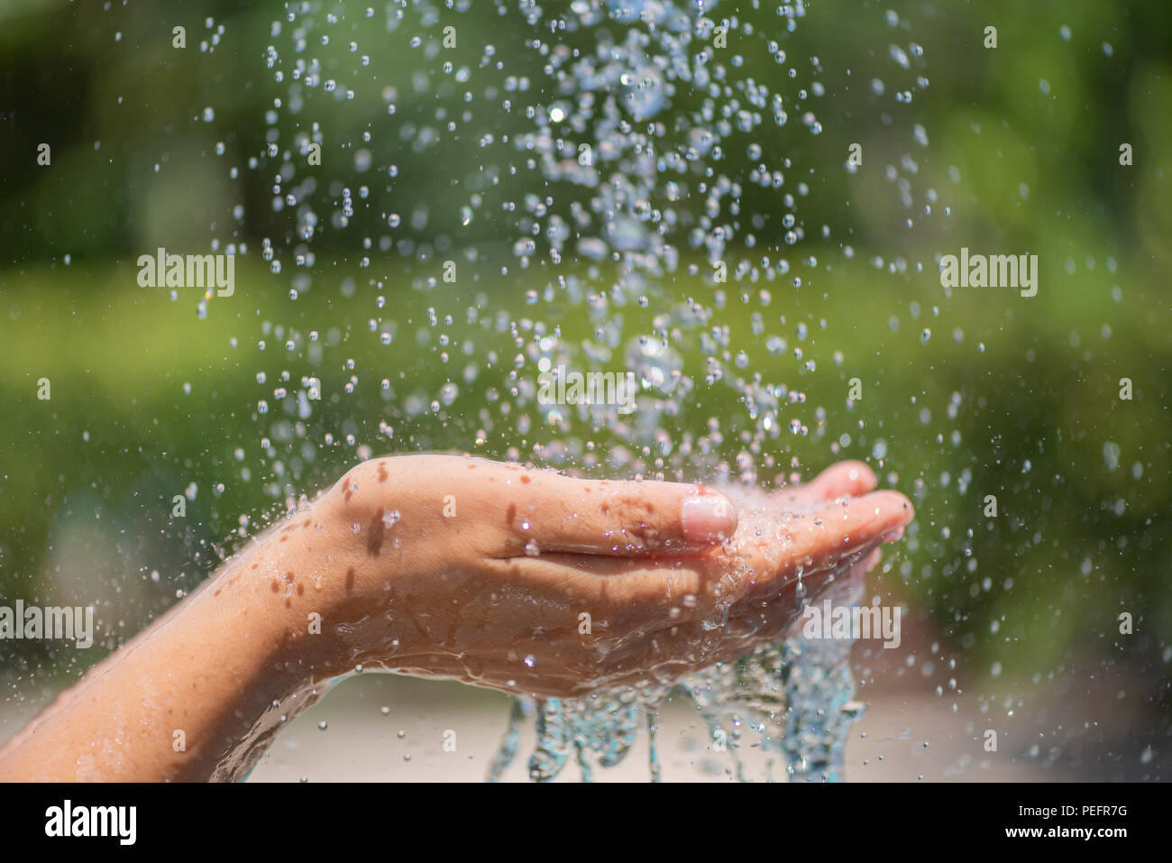 Water pouring in woman's hands. World Water Day concept Stock Photo - Alamy