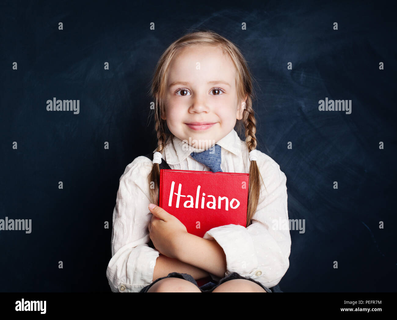 Italian language concept. Cheerful child pupil with italian book ...