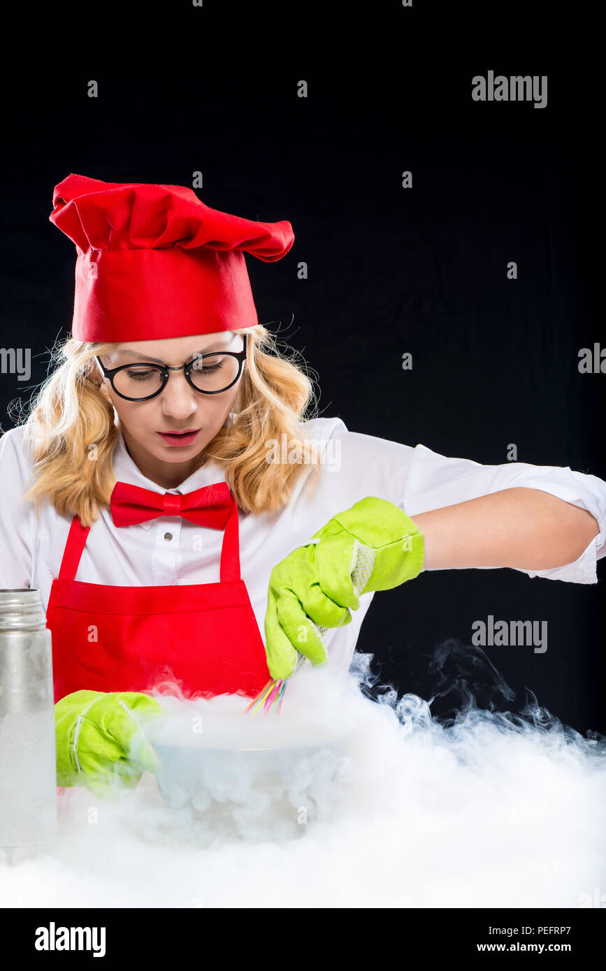 Woman animator cook doing experiments with liquid nitrogen, portrait on ...