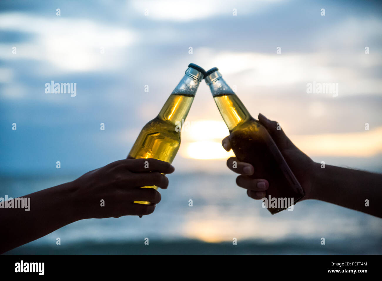 Hand holding two bottles beer hi-res stock photography and images - Alamy