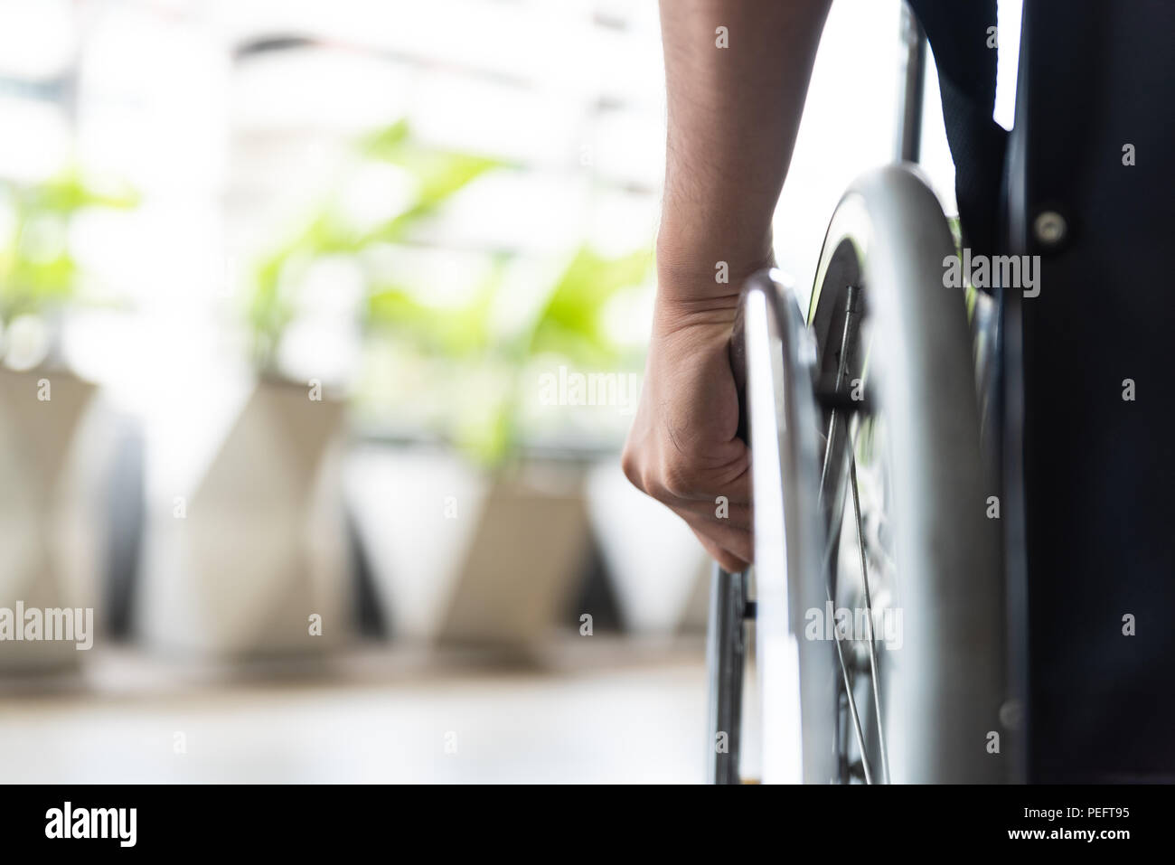 closeup disabled man hand on wheel of wheelchair Stock Photo - Alamy