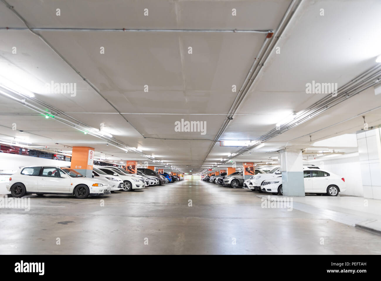 Underground interior garage parking lot with many cars Stock Photo - Alamy
