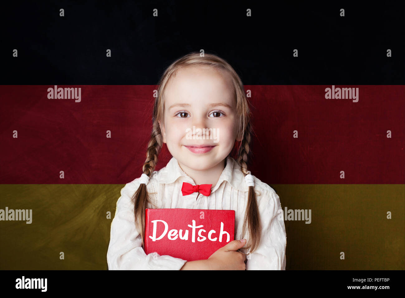 Learning german language concept with happy child girl and german flag ...