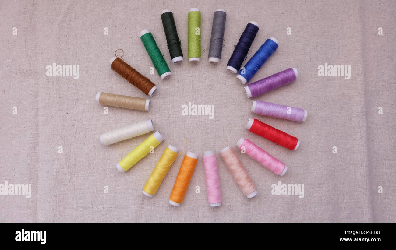 Colorful thread rolls arranged in a circle Stock Photo - Alamy