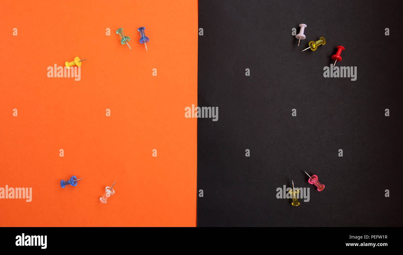 Colorful push pins with orange and black background Stock Photo - Alamy