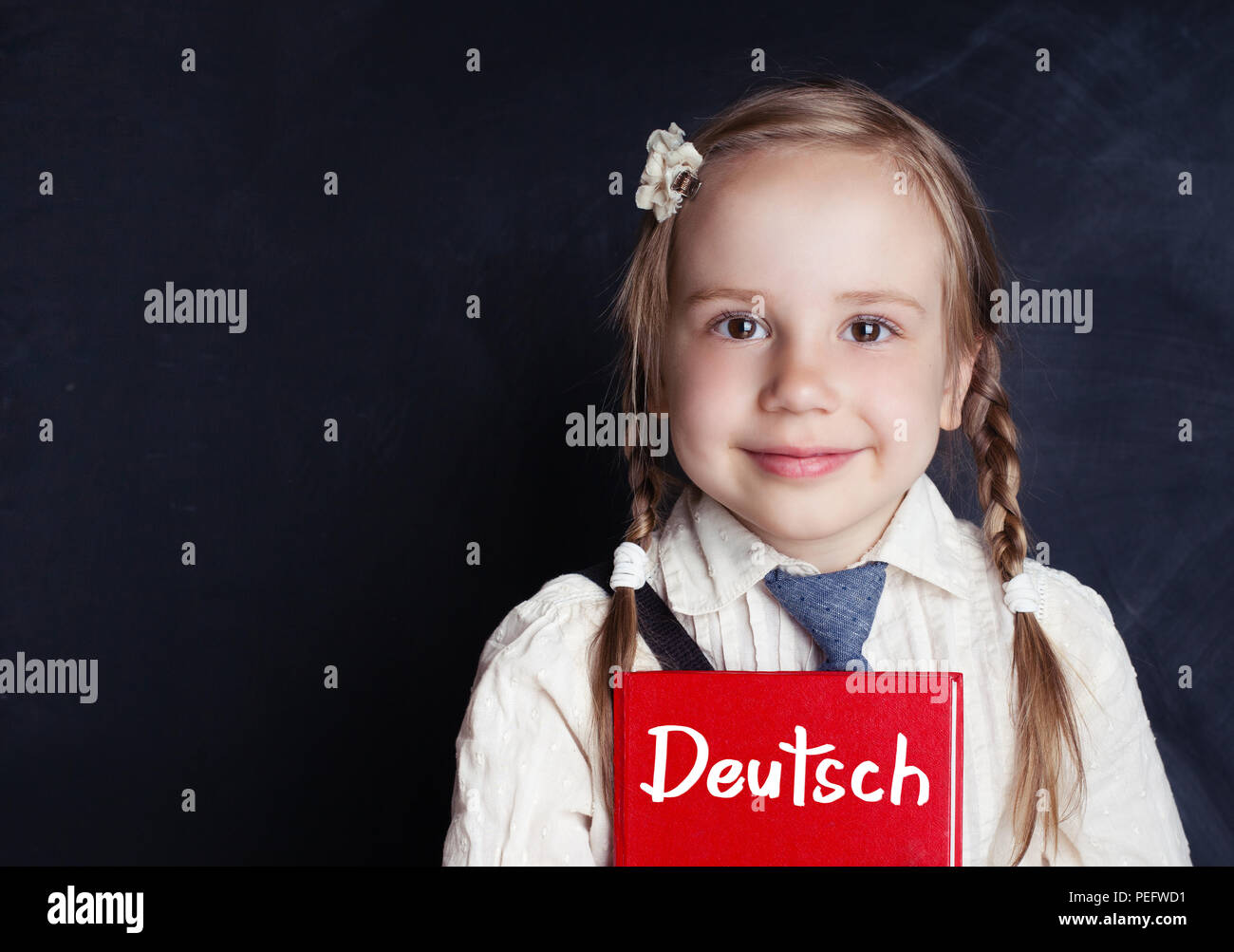 German concept with little schoolgirl student with pigtails hair. Smart ...
