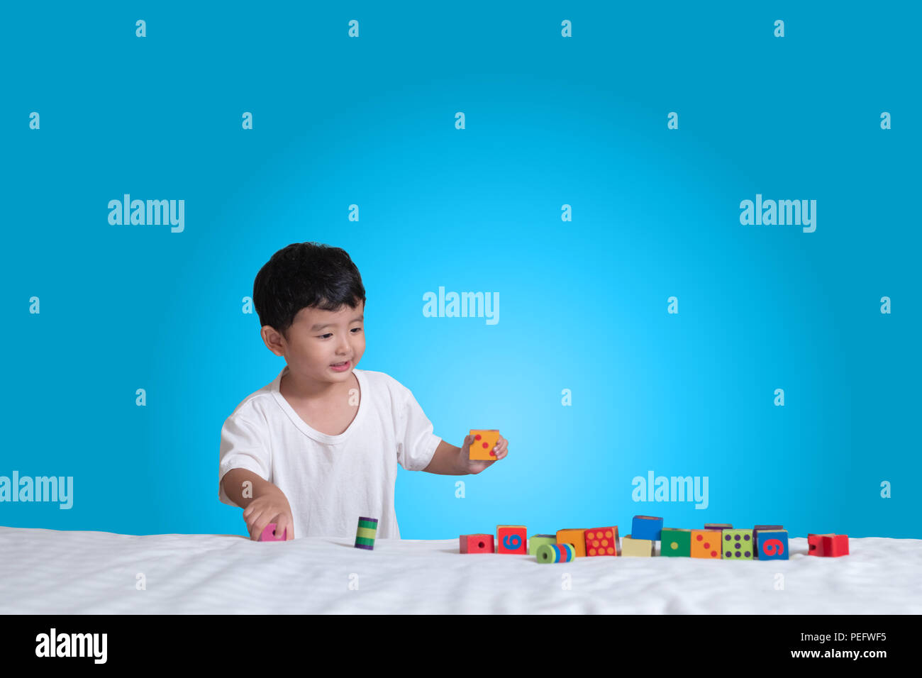 3 years old little cute Asian boy play toy or square block puzzle at ...