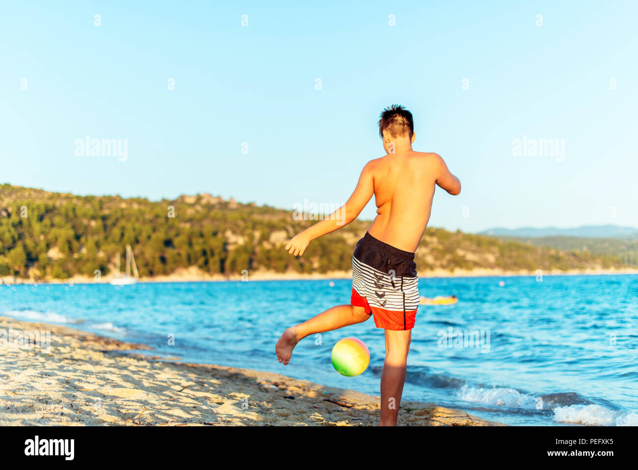 Children playing football on the sand beach Stock Photo - Alamy