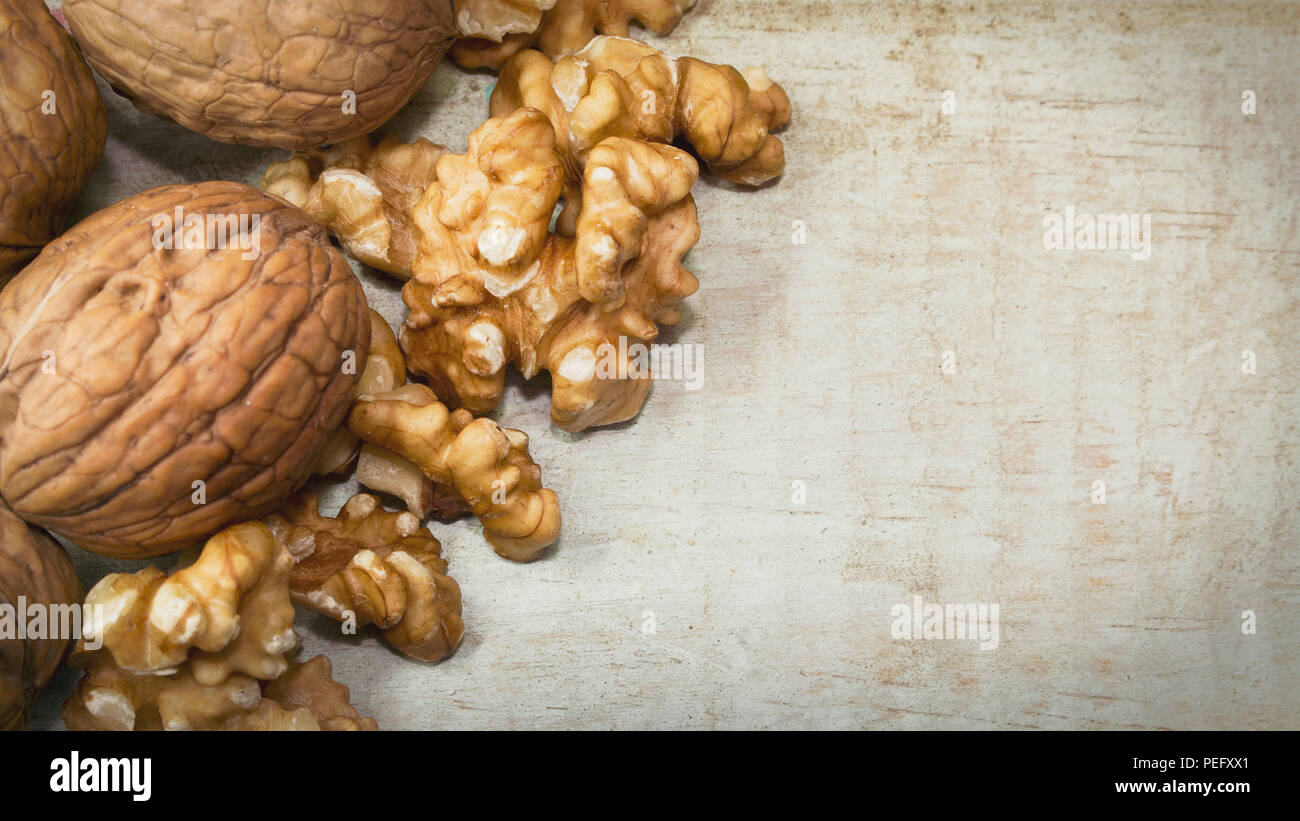 Horizontal close up photo of mix of walnut shells and walnuts kernels ...