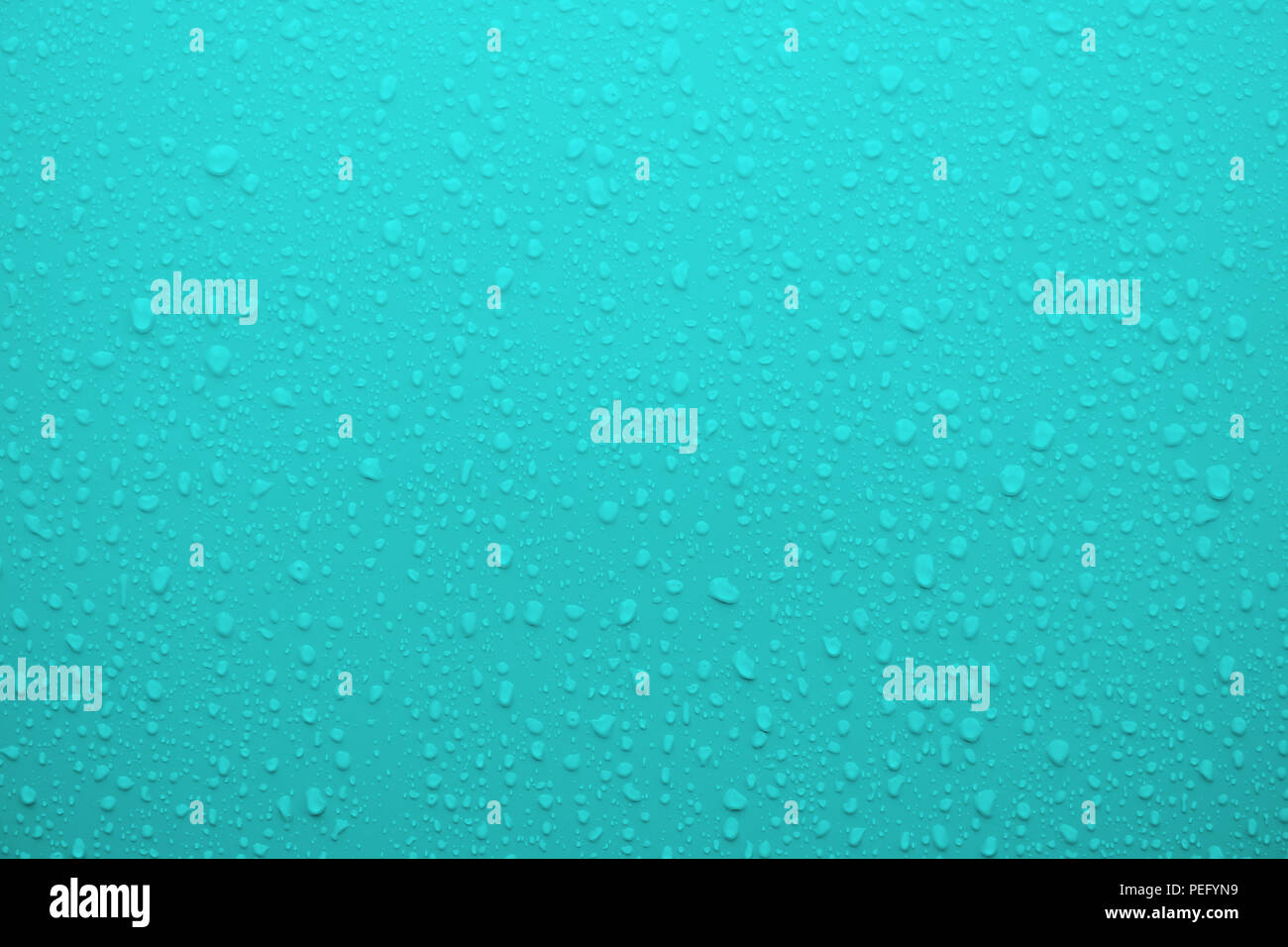 Condensed water drop on cyan blue surface as background Stock Photo - Alamy