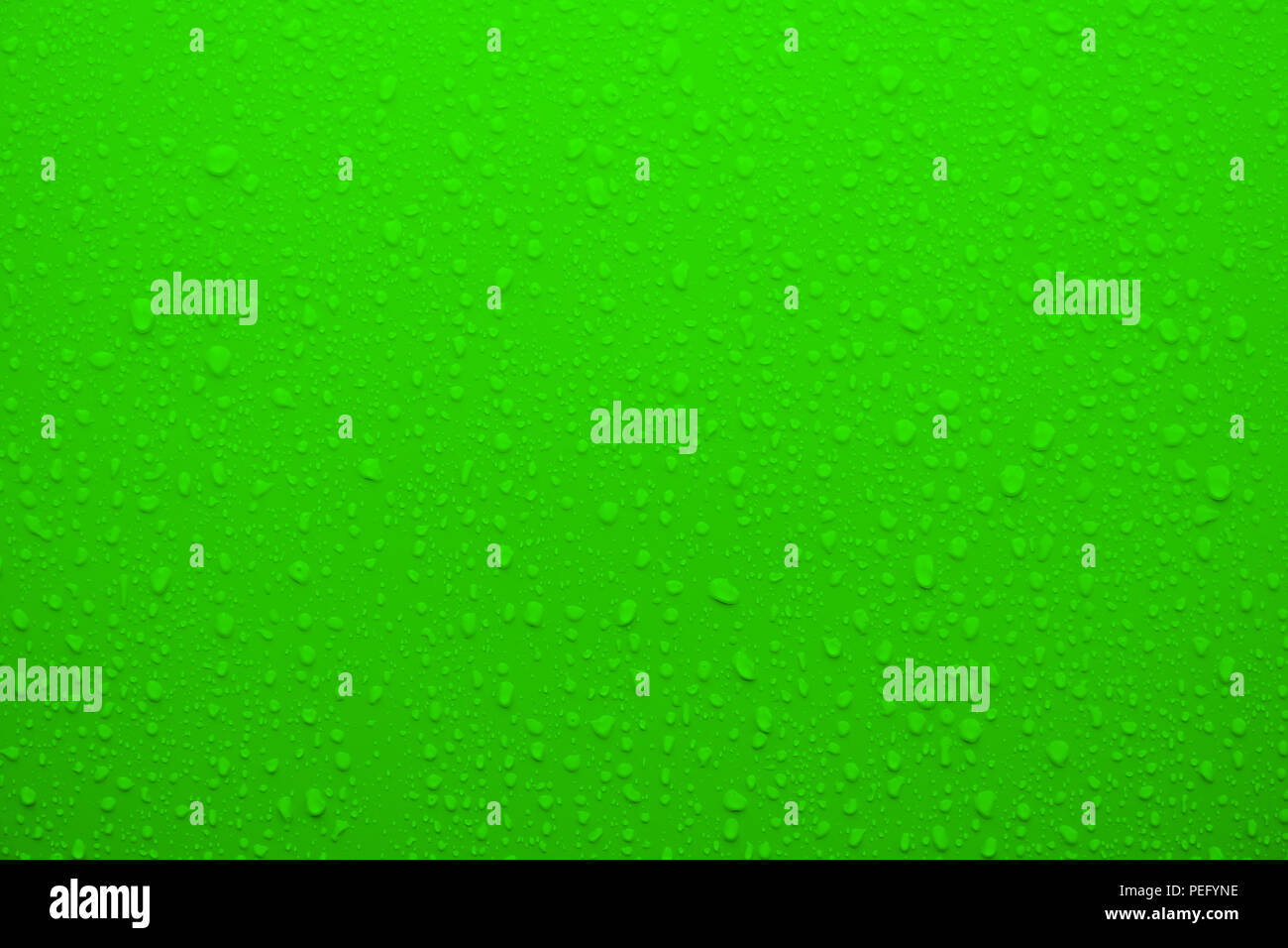 Condensed water drop on bright green surface as background Stock Photo ...