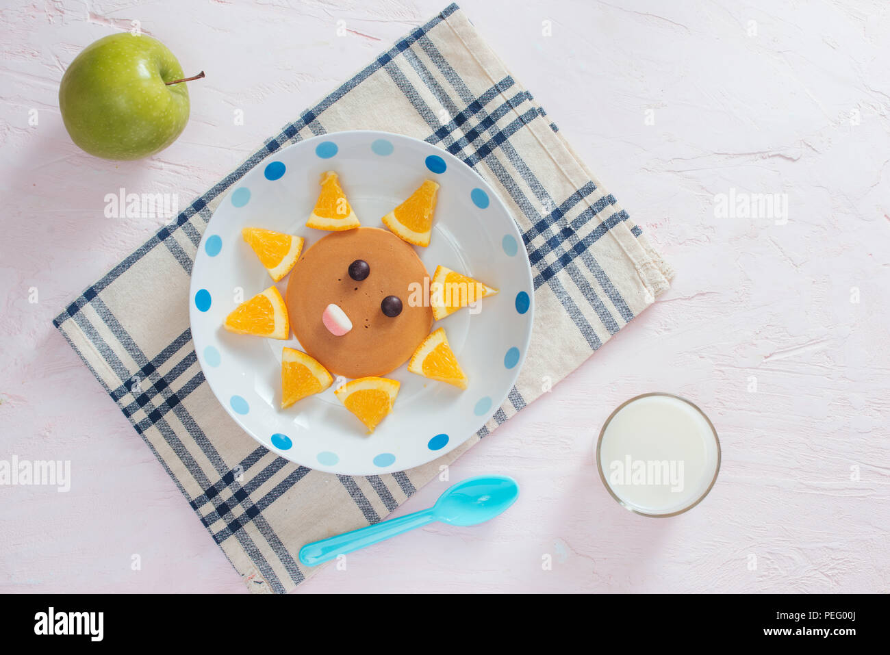 Funny pancakes with orange for kids breakfast Stock Photo - Alamy