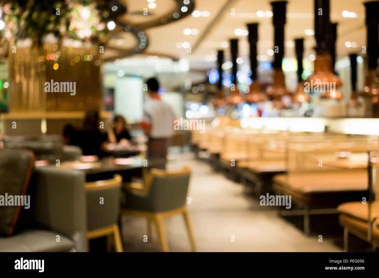 Abstract blur restaurant interior as background. Waiter recieving food ...