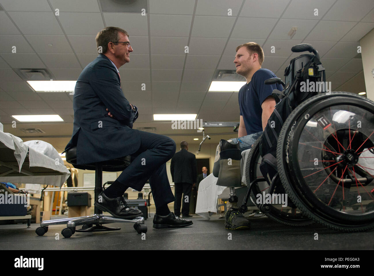 Secretary of Defense Ash Carter speaks with a wounded warrior who is ...
