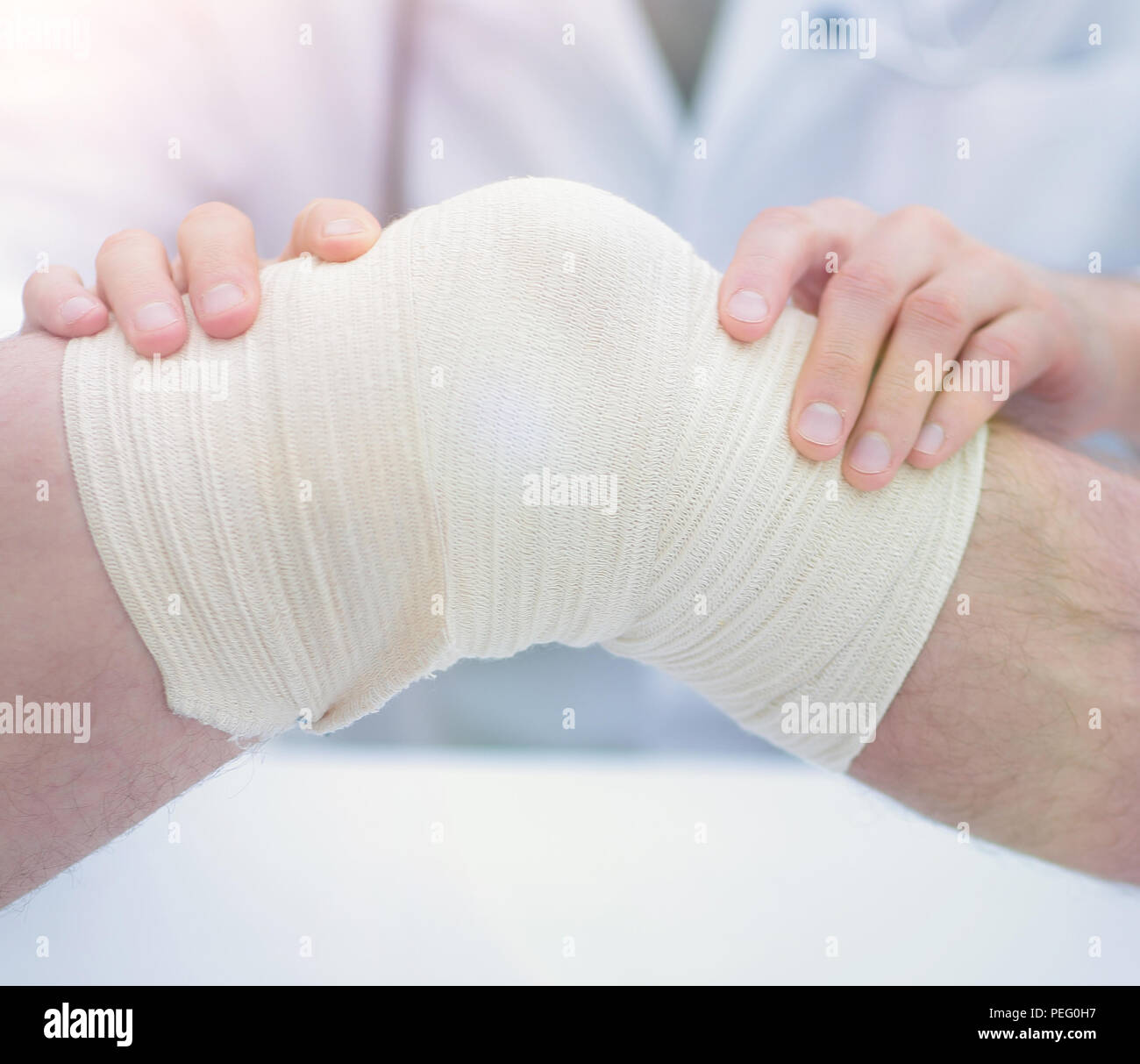 traumatologist ,applying a bandage on the knee Stock Photo - Alamy