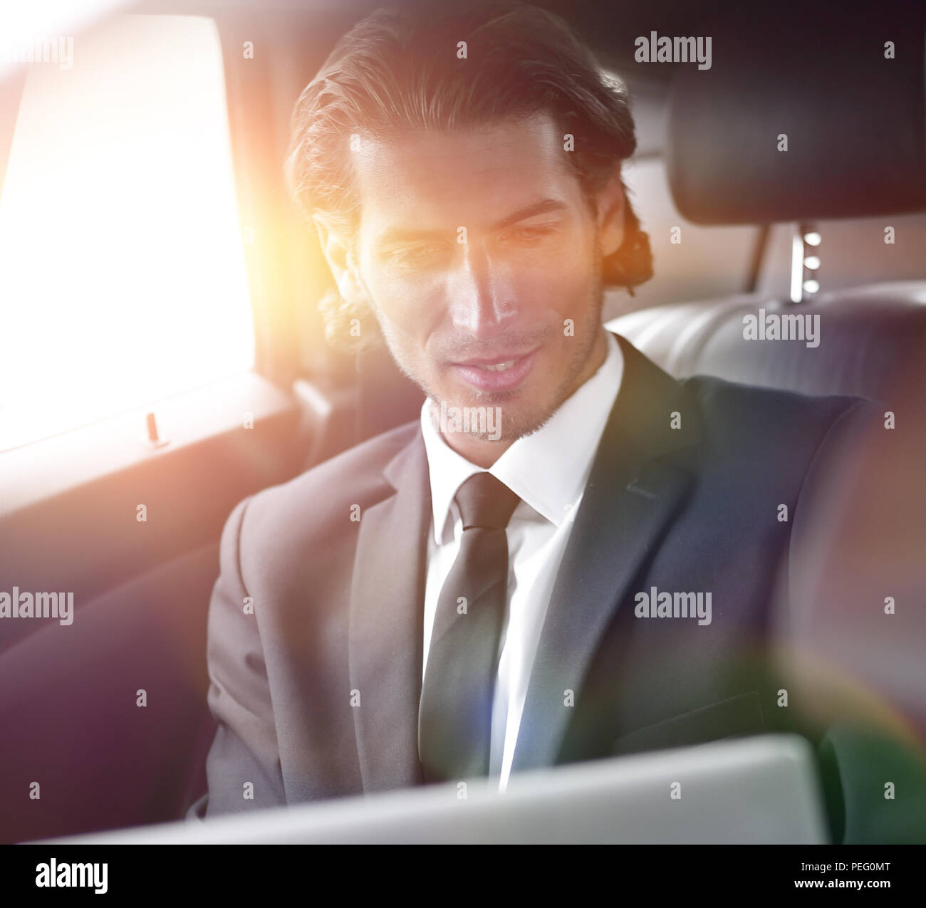 man working on laptop while sitting in the car Stock Photo - Alamy