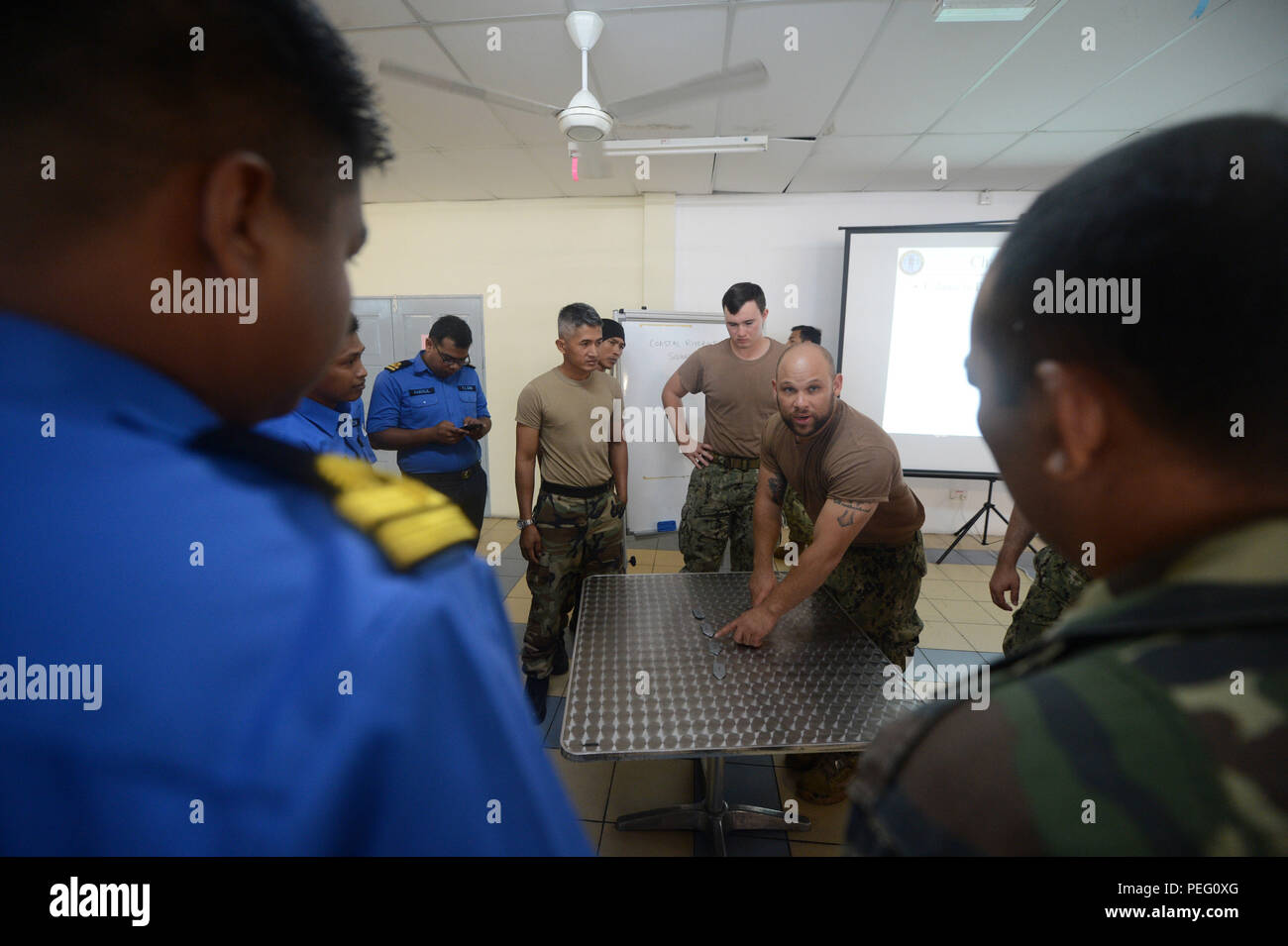 Electrician's Mate 1st Class demonstrates boat formations to Royal ...