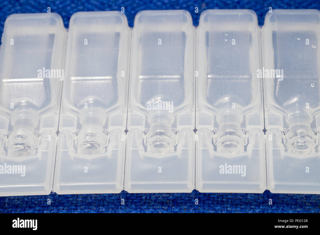 IV solution plastic bottle ampule on blue fabric surface Stock Photo ...