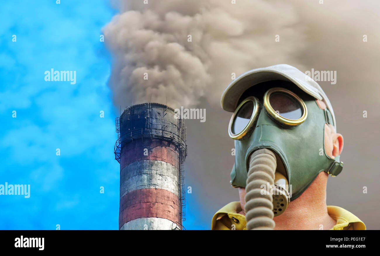 Person in gas mask on industrial smoking pipe background taken closeup ...